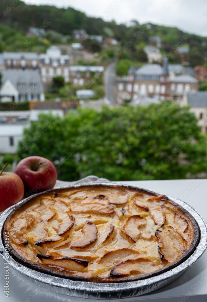 Tasty sweet French dessert, baked apple cake and view on old houses of ...