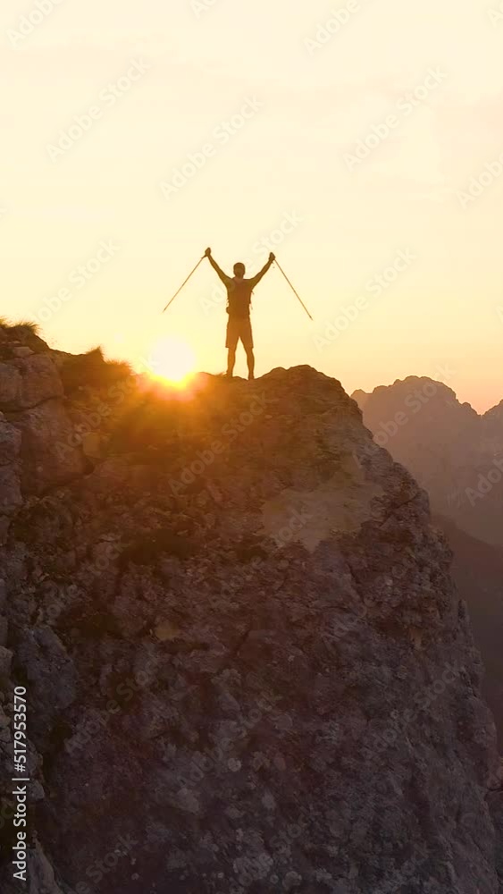 DRONE, SUN FLARE, SILHOUETTE: Cheerful male hiker celebrates catching ...