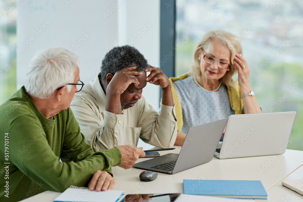 A senior african man having trouble learning the use of the internet on ...