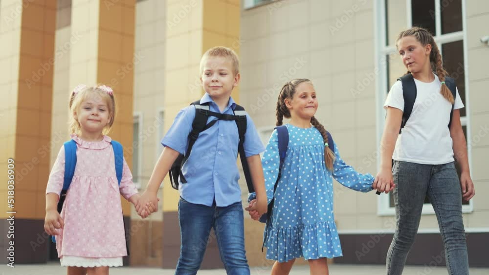 Children return to school with backpacks. Family of children goes to ...