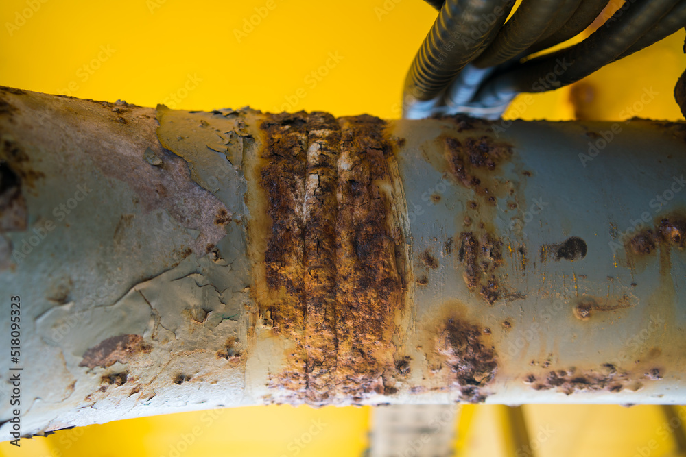 Steel pipe with blister paint, rust paint peeling off against the ...