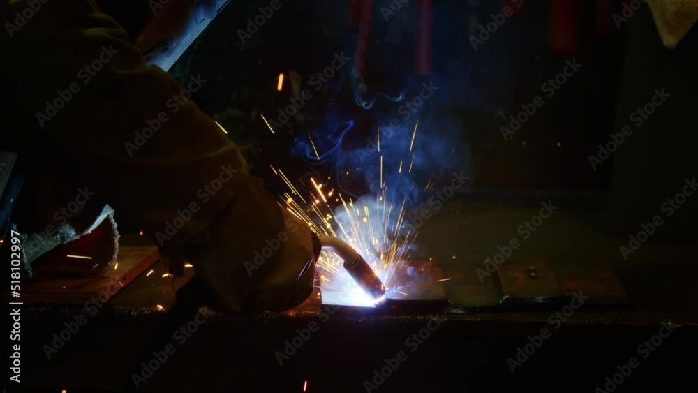 close-up, A man welds plates for body armor from springs. homemade ...