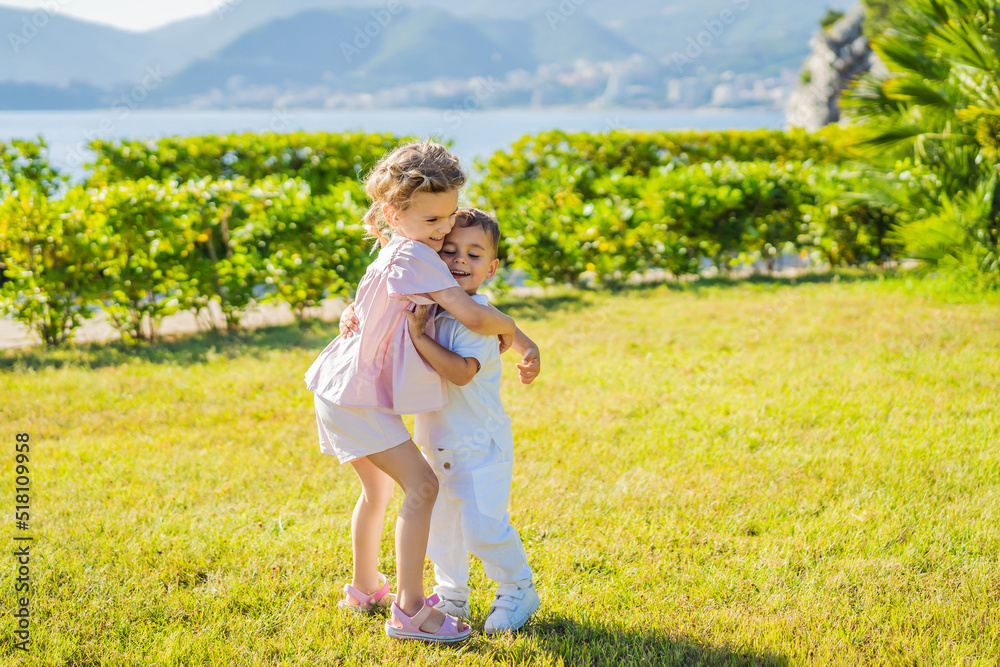 Portrait of two cute adorable baby children toddlers hugging and ...