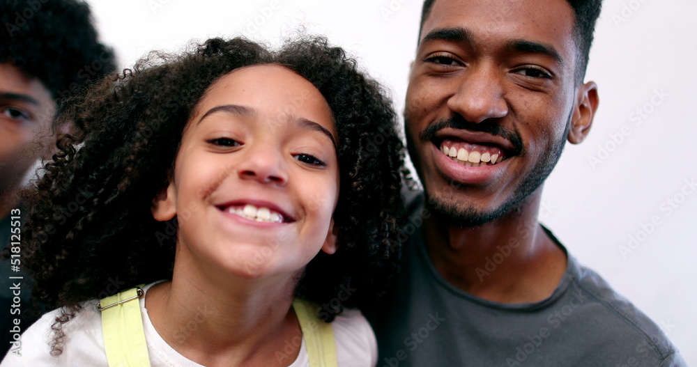 Siblings smiling at camera. Mixed race ethnically diverse brother and ...