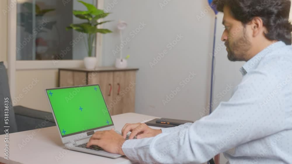 Vertical shoudler shot of corporate employee busy working on laptop ...