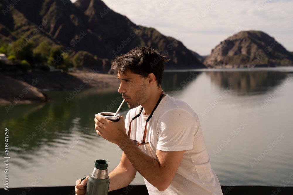 Drinking mate in the morning. Closeup view of a young man drinking ...