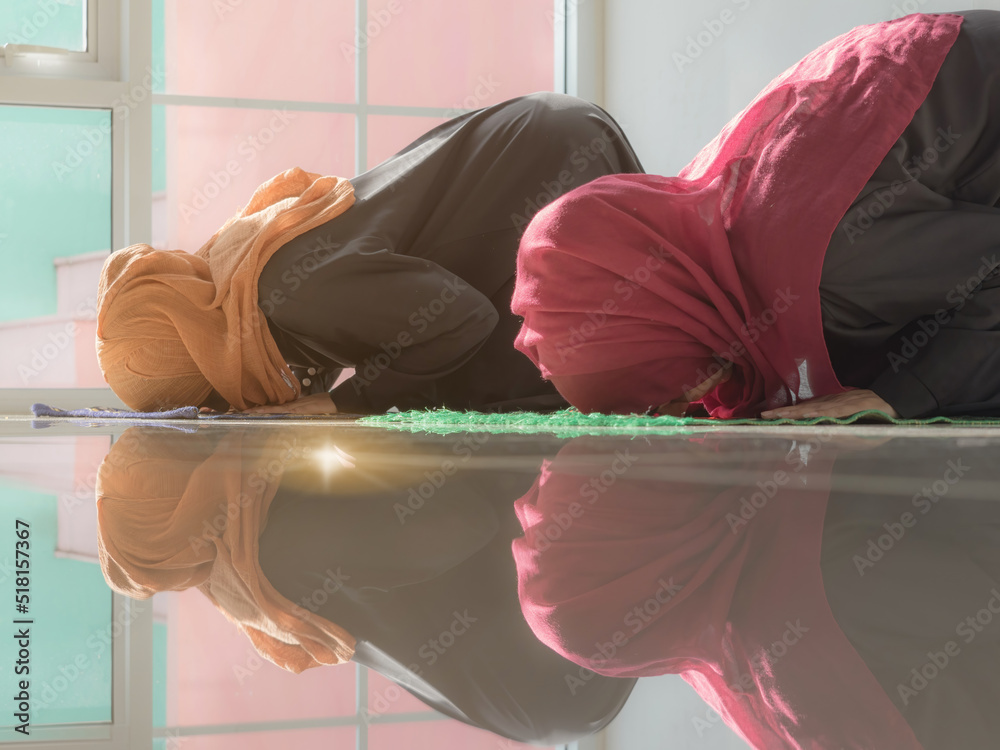 Close up, Two Muslim women making prostration praying in Sujud pose ...