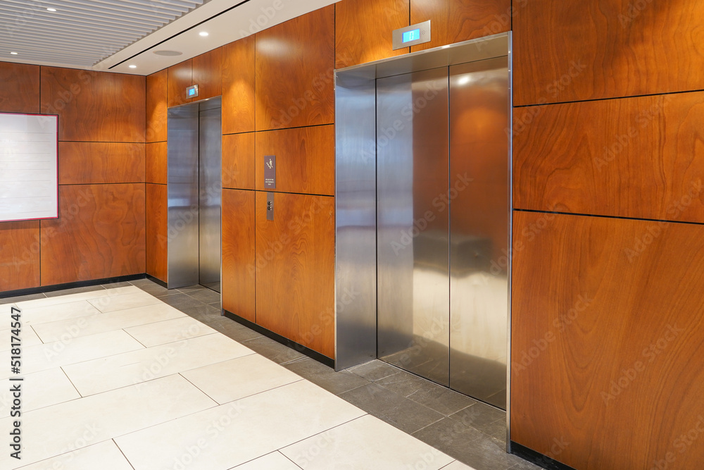 Two elevator doors in office building. Wide angle view of modern wood ...