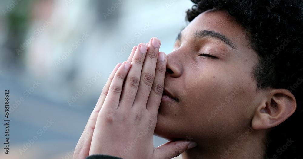 Young boy praying to God. Religious Mixed race child looking at sky ...