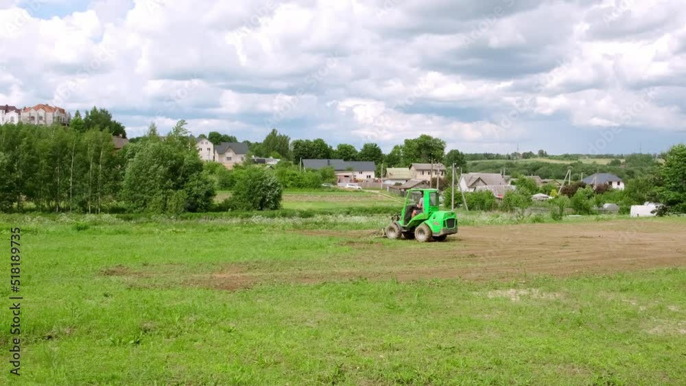 Mini skid steer loader clear the construction site. Land work by the ...