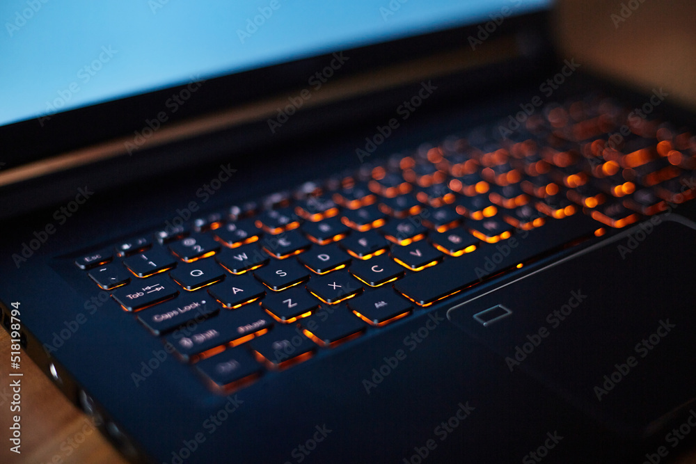 Laptop keyboard with orange neon illumination, backlit keyboard. Stock ...