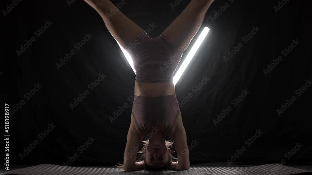 Fit woman practicing yoga poses. Silhouette girl doing exercise in ...