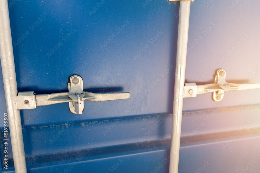 Close-up detail view of big blue metal freight cargo container door ...