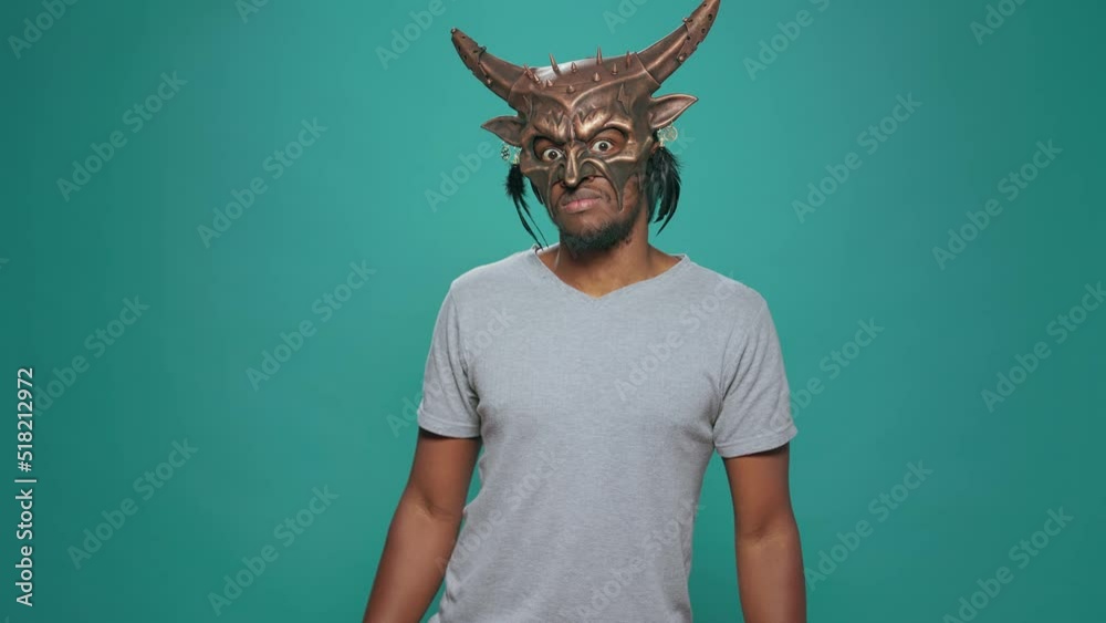 Video „Young man wearing ancient tribal mask with sacral pattern and ...