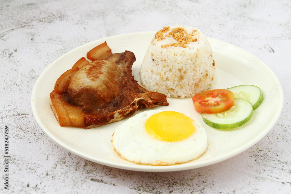 Freshly cooked Filipino food called Pork Chop Silog or pork chop, egg ...