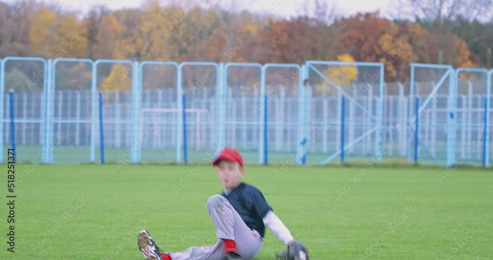 Baseball tournament at school, the boy pitcher catches a fastball in ...