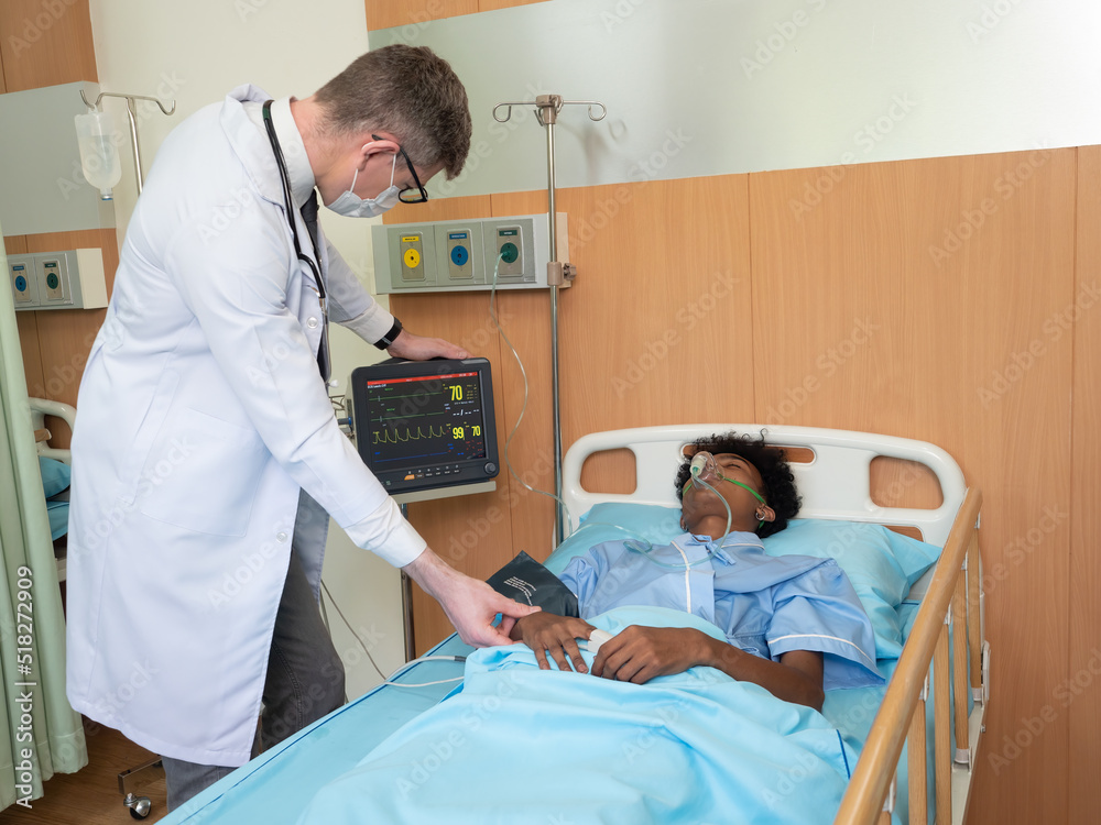 At hospital intensive care unit patient in coma lay on bed ...