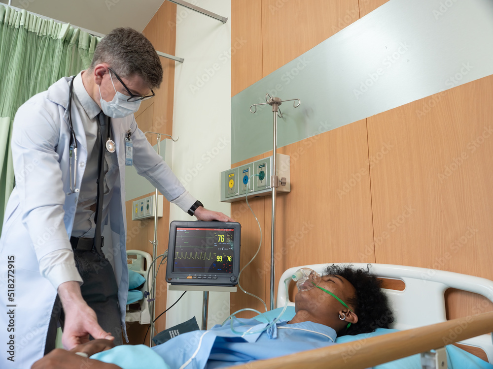 At hospital intensive care unit patient in coma lay on bed ...