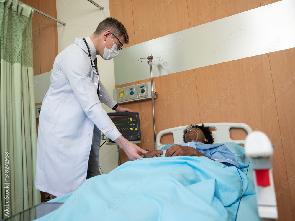 At hospital intensive care unit patient in coma lay on bed ...