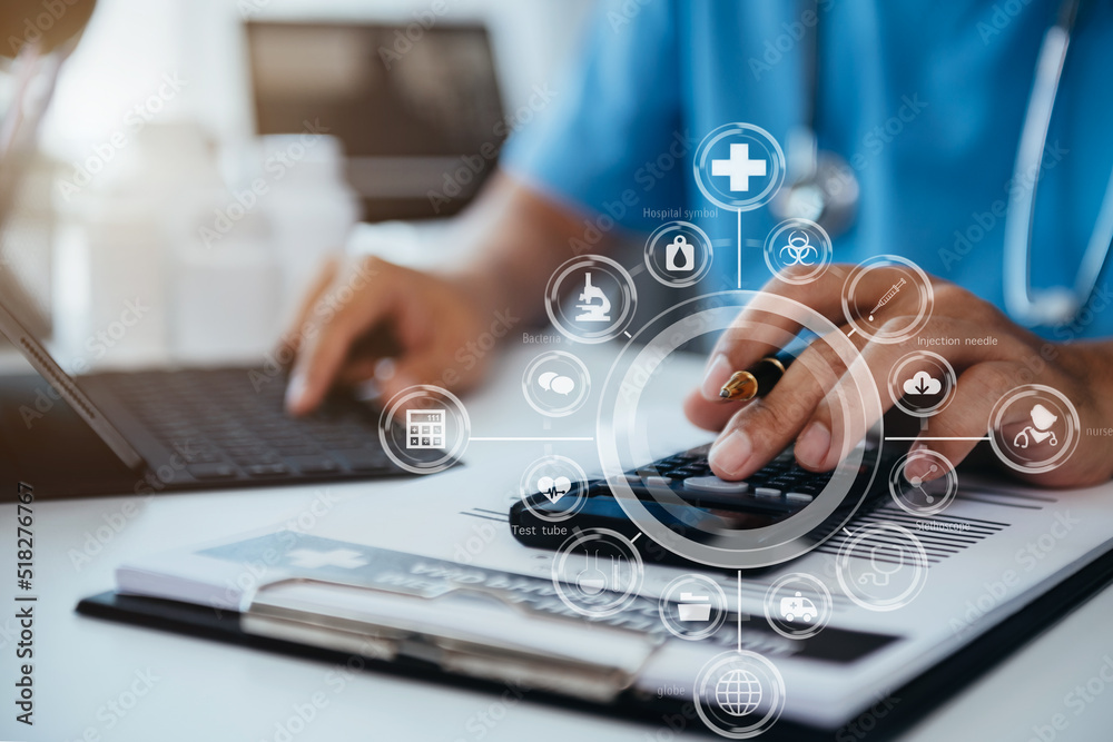 Healthcare costs and fees concept. doctor used a calculator and tablet ...