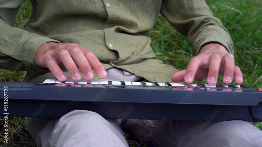 Video Stock Fingers of a teenage boy's hands sitting and playing ...