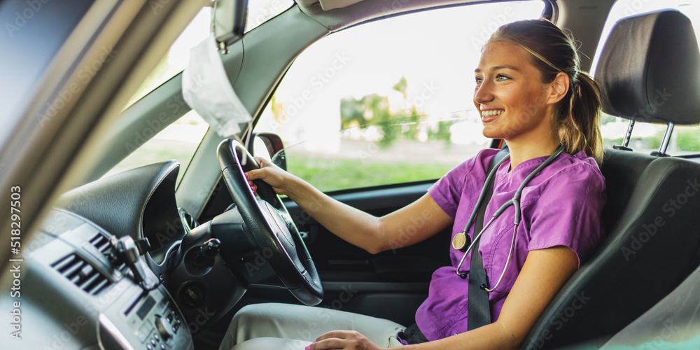 Caucasian female doctor driving her car. Young smiling nurse driving ...
