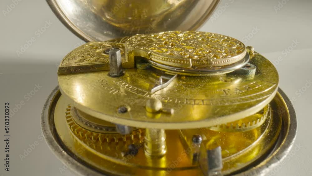 Clockwork mechanism with rotating spring, gears and gearing. Round ...