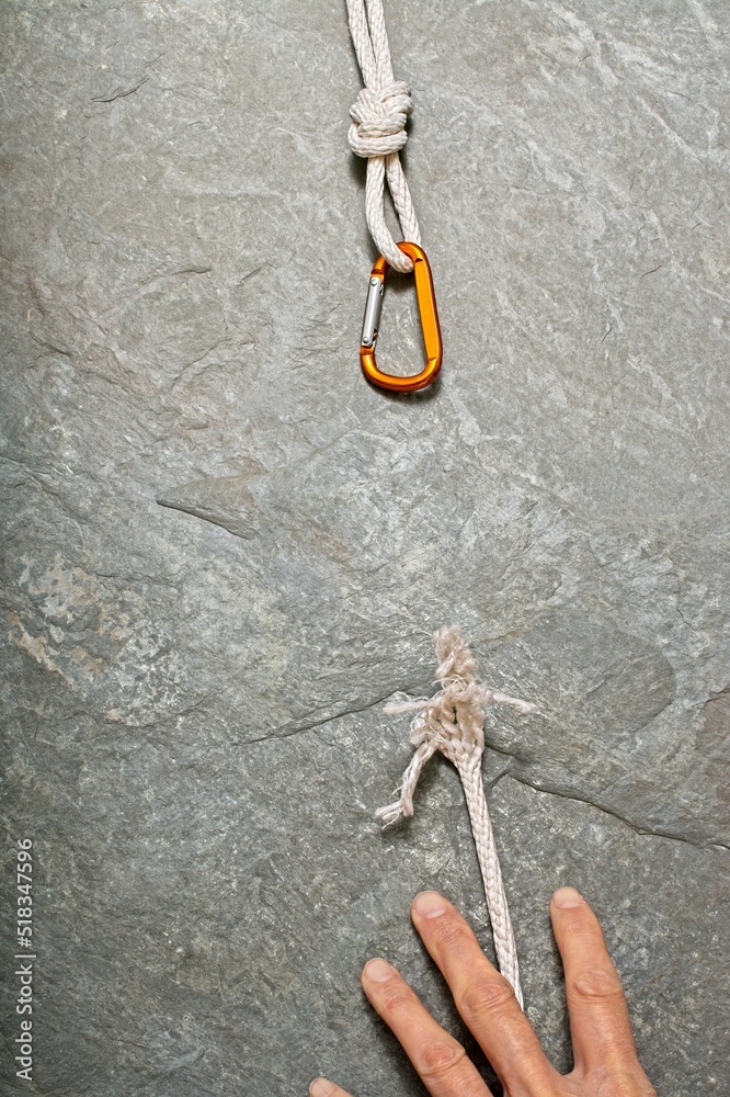 Tension concept with human hand grabbing for frayed end of white ...