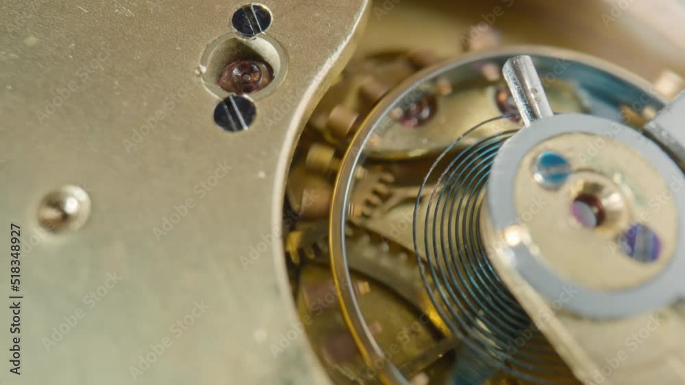 Moving gold gears inside working pocket watch mechanism. Working clock ...