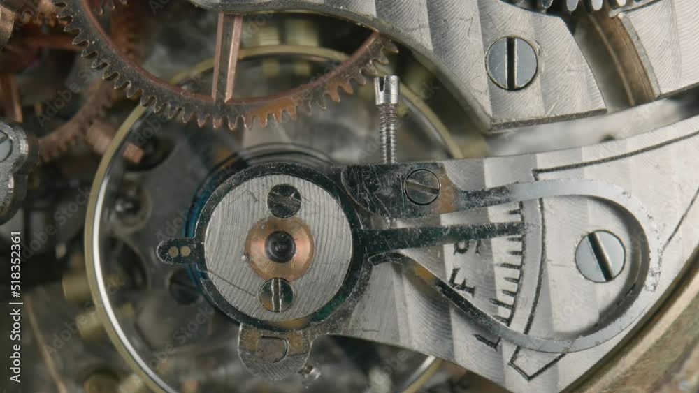 Moving gold gears inside working pocket watch mechanism. Working clock ...