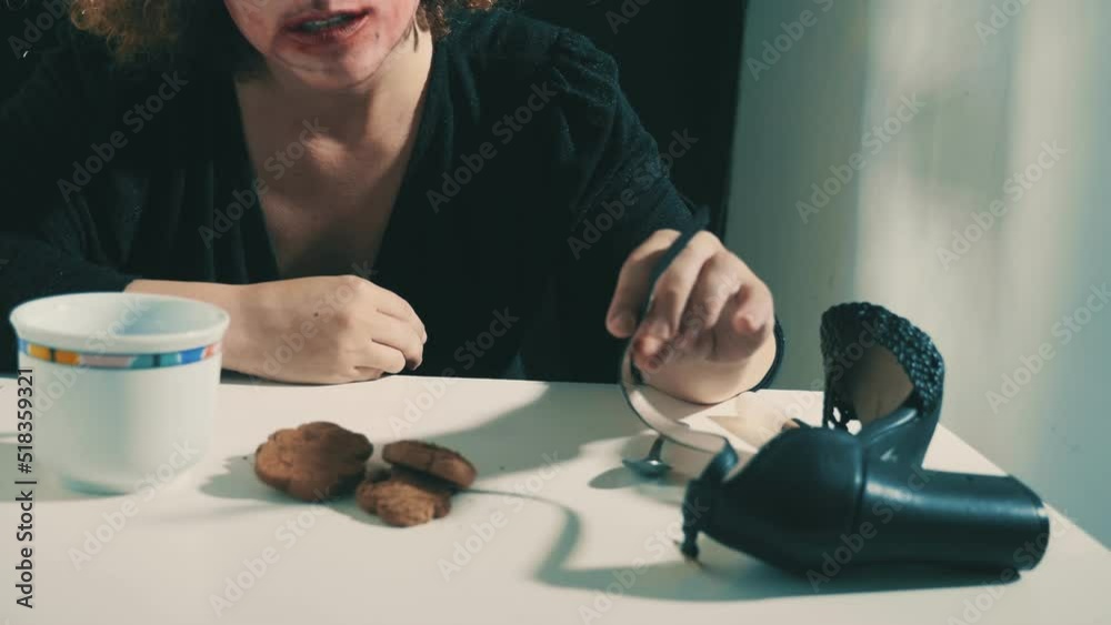 brutalization, alienation-woman with catatonic gaze plays with the shoe ...