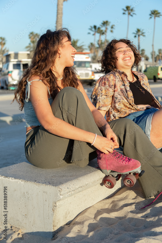 Gen-z friends having fun roller skating together by the beach Stock ...