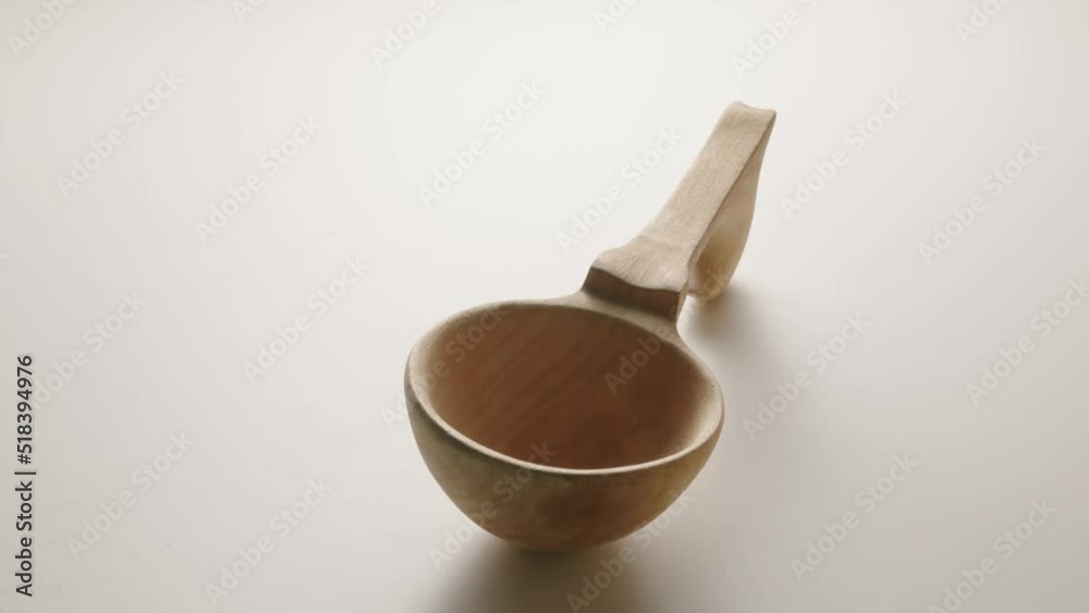 Antique wooden spoon rotating on light gray studio background. Carved ...