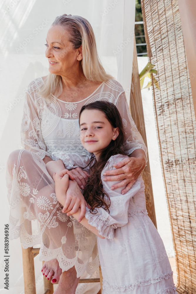 Pretty grandmother and granddaughter in white posing at terrace Stock ...