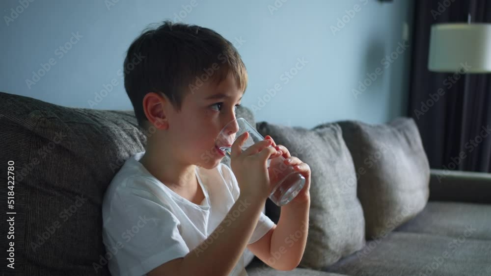 Cute little baby boy drinking a glass of water in home. little child ...