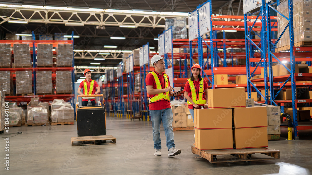 Male and female warehouse workers Working at a distribution center ...