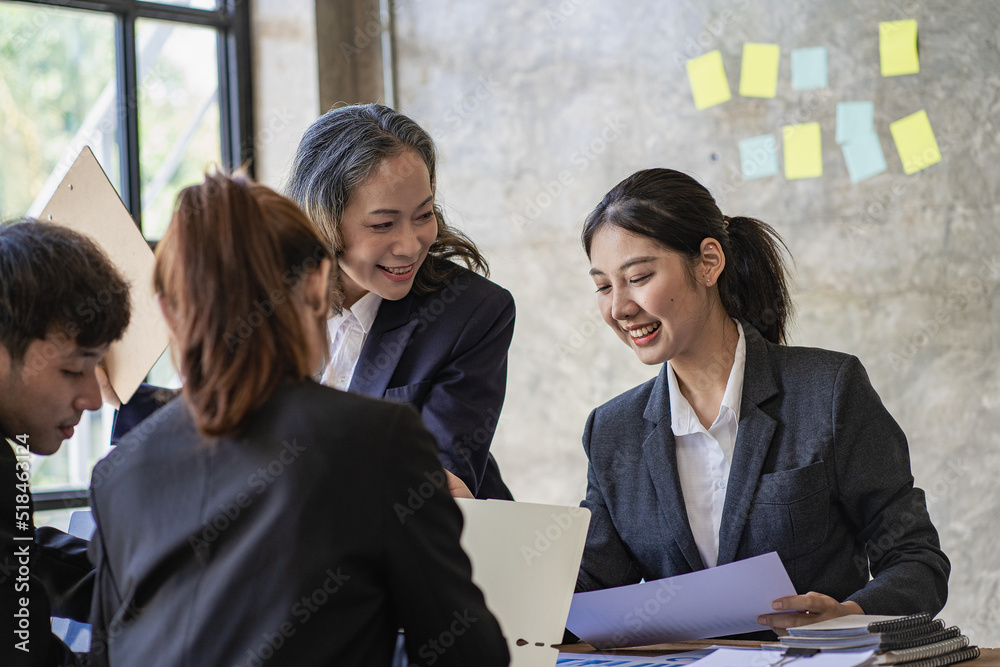 Formally dressed Asian CEOs, generations of businessmen gather in a ...