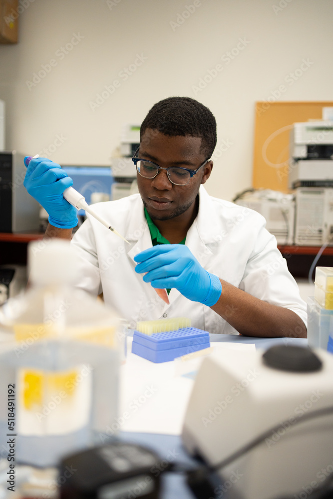 Black Man Scientist Focused Using The Pipette In The Lab. Stock Photo ...