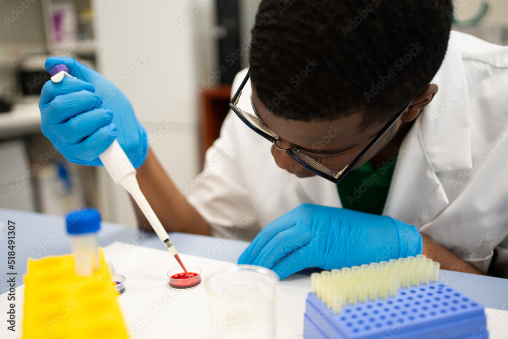 Black Man Scientist Focused Using The Pipette In The Lab. Stock Photo ...