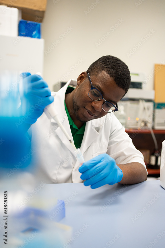 Black Man Scientist Focused Using The Pipette In The Lab. Stock Photo ...
