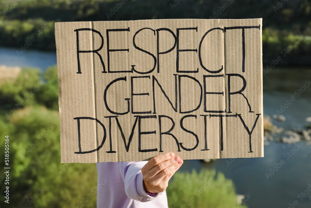 Woman holding sign with text Respect Gender Diversity outdoors Stock ...