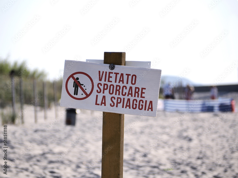 White rectangular sign on the beach "Vietato sporcare la spiaggia ...