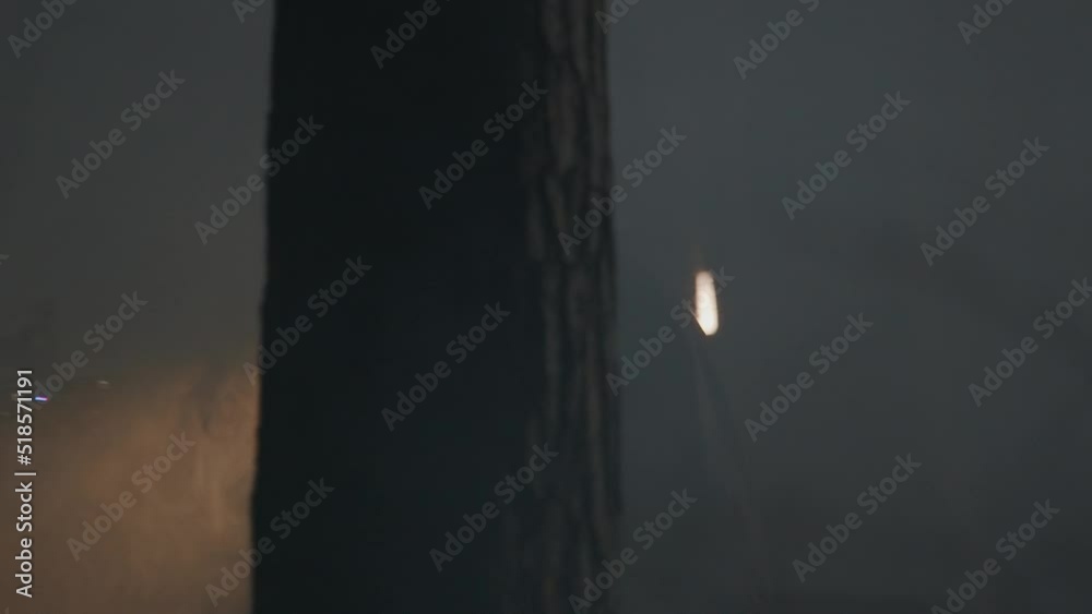 Silhouette of young mysterious man walking through empty park at night ...