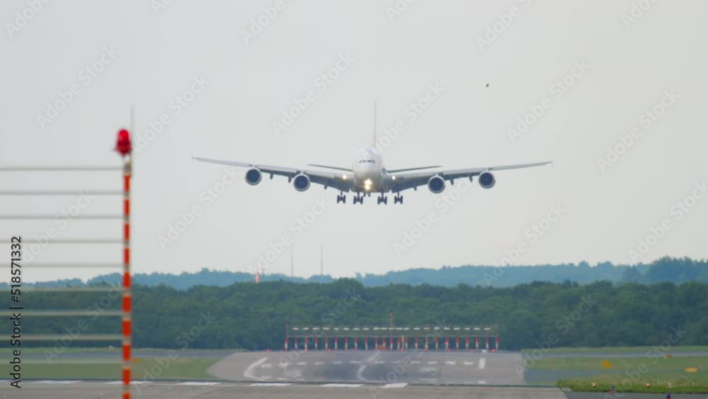 Front view of a four-engine double-deck wide-body aircraft approaching ...