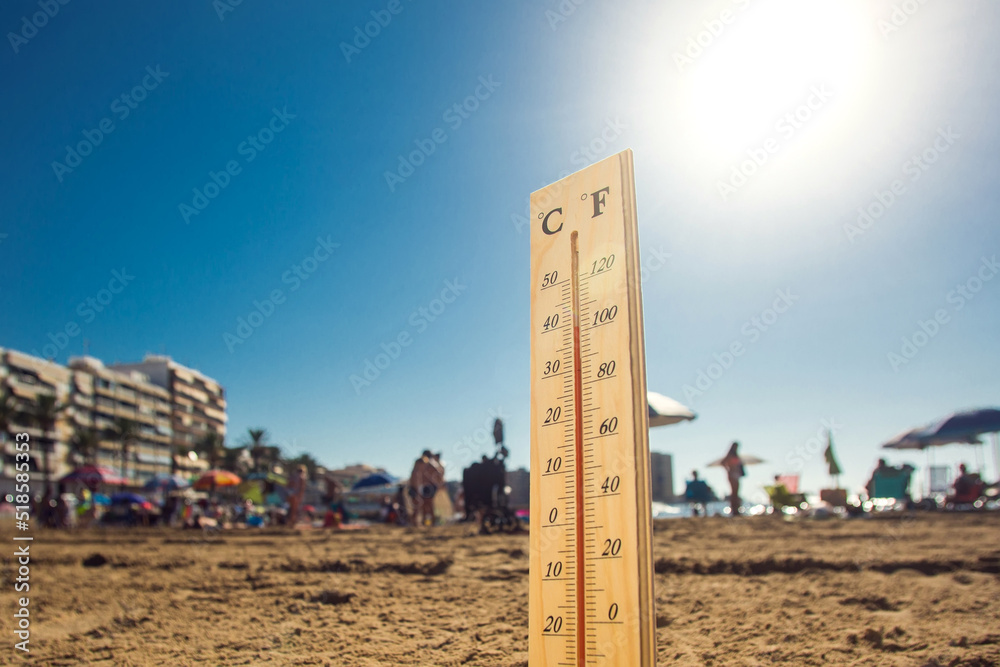 Hot weather. A temperature scale on a beach shows high temperatures ...