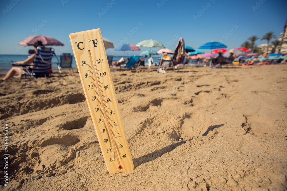 Hot weather. A temperature scale on a beach shows high temperatures ...