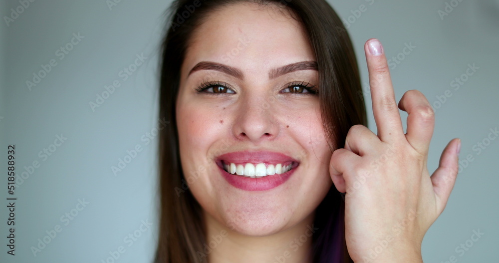 Foto de Young woman giving middle finger, pretty girl with attitude shows offensive gesture ...