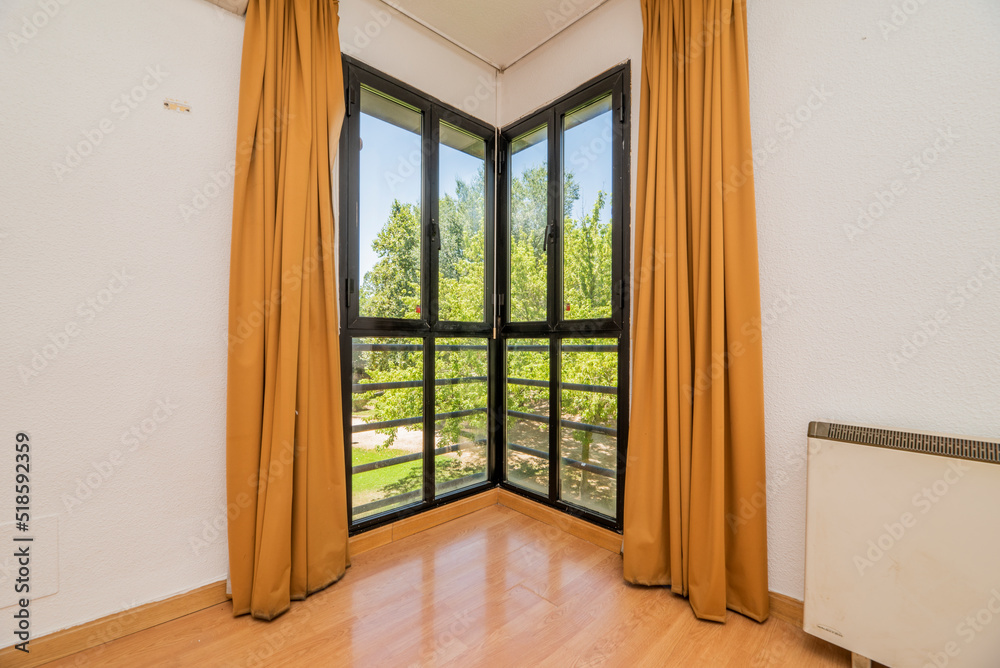 Bay window of a house in the corner of a room with black aluminum ...