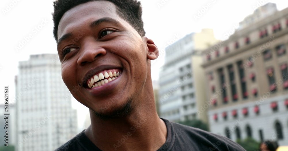 African black man smiling and laughing outside, real authentic people ...
