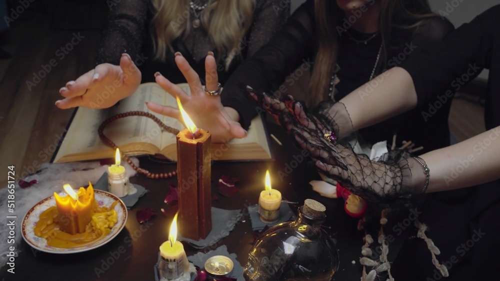 4K. Three female witches in a dark room conduct mystical sessions Stock ...